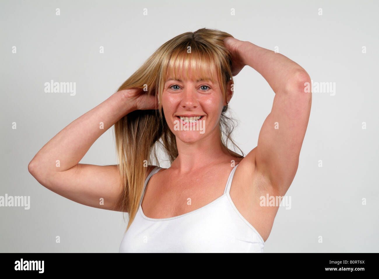 Portrait of Woman with her hands in her hair Stock Photo - Alamy