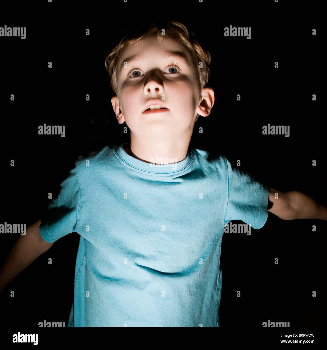 young boy looking scary in the dark Stock Photo - Alamy