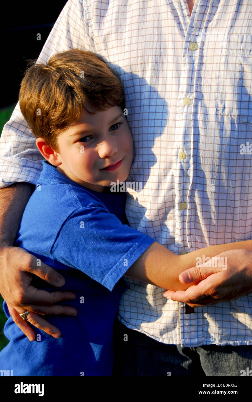 Little boy hugging his father Stock Photo - Alamy