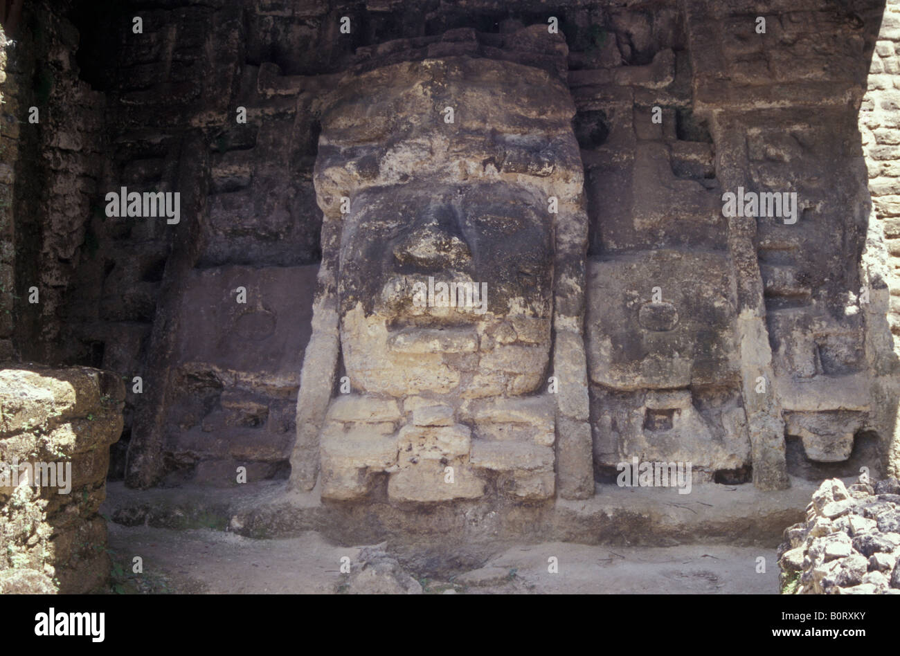Huge limestone mask at the Mask Temple, Mayan ruins of Lamanai, Belize ...