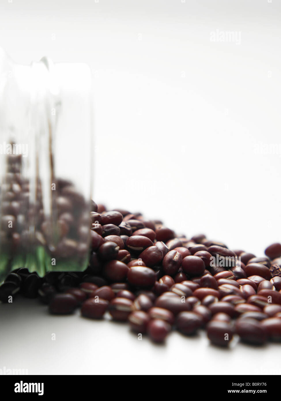 Beans spilled from jar Stock Photo - Alamy