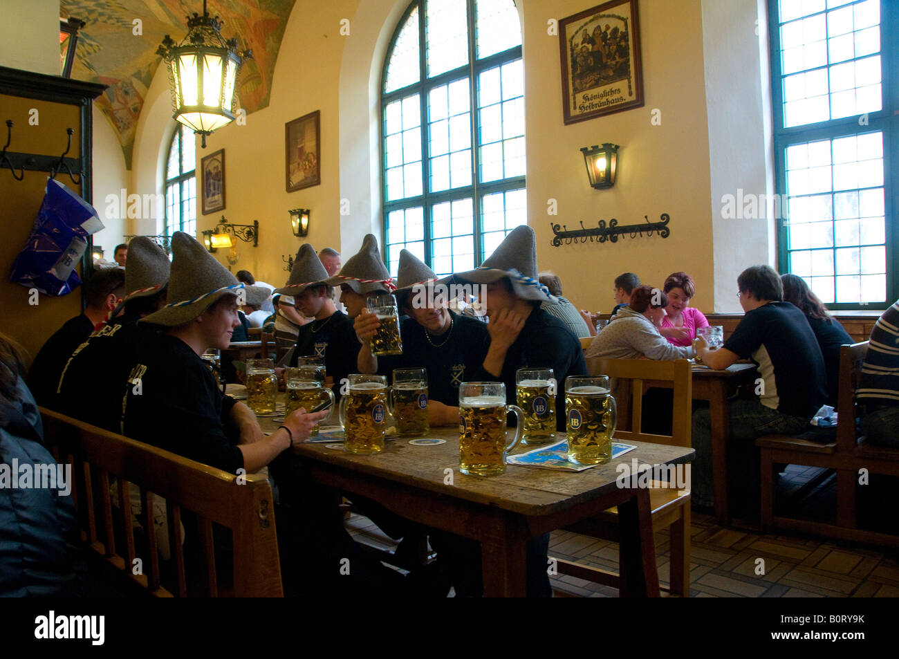 Youngsters drinking beer at the famous old Hofbrauhaus beer hall in the ...