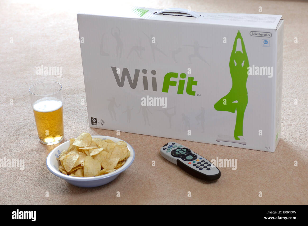 a nintendo wii fit all boxed up ready to use with some junk food Stock ...