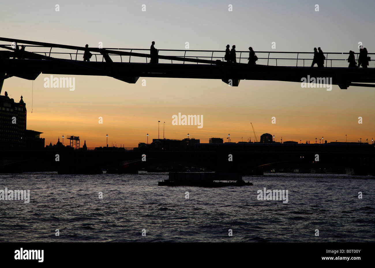 Pedestrians Crossing The Millennium Bridge London Stock Photo Alamy