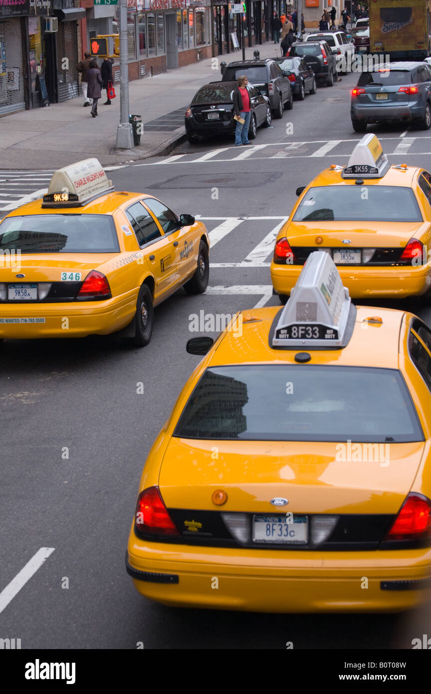 Three taxi cab at the junction of 13th Street and 6th Avenue New York ...