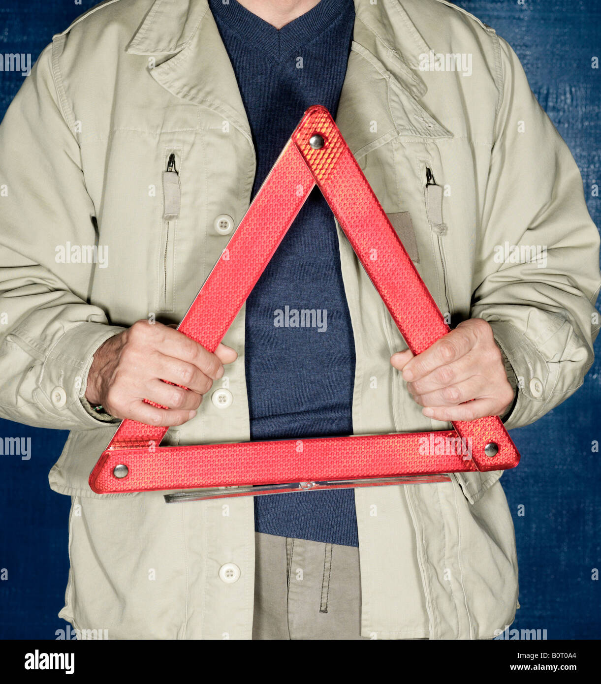 man holding warning triangle Stock Photo - Alamy