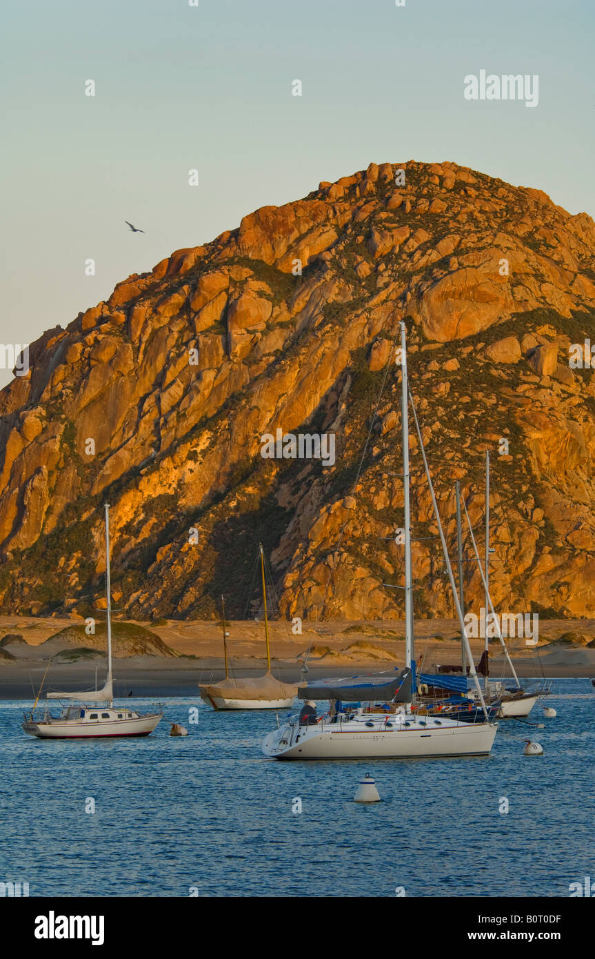 Sailboats anchored in front of Morro Rock at sunrise Morro Bay ...
