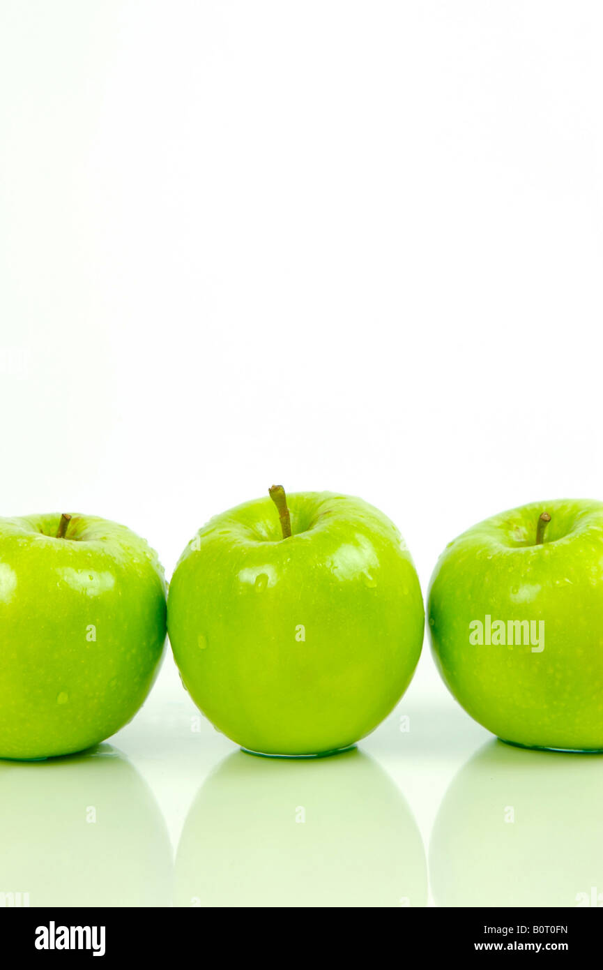 Green apples isolated against a white background Stock Photo - Alamy