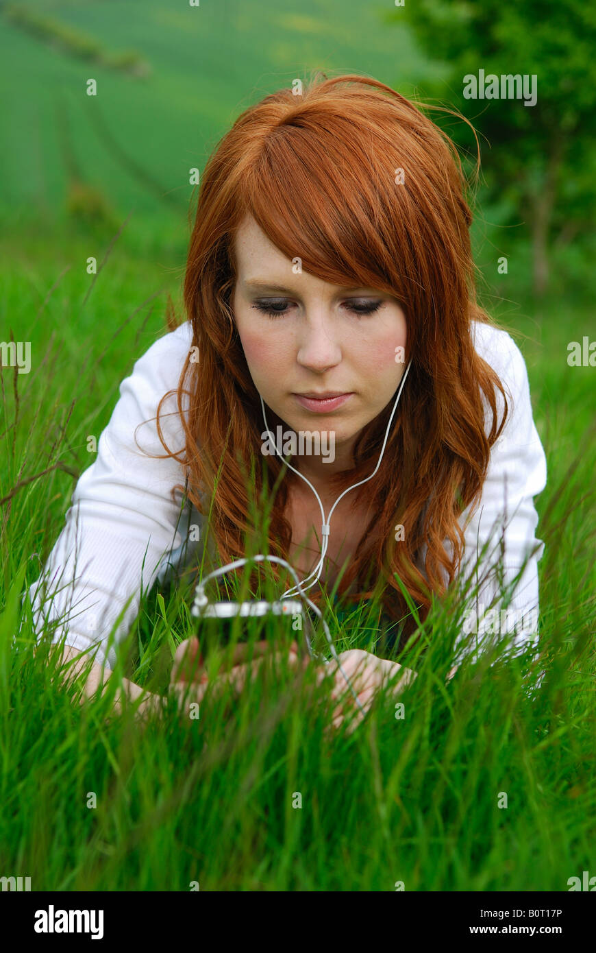 Female Listening to Mp3 Player Stock Photo - Alamy