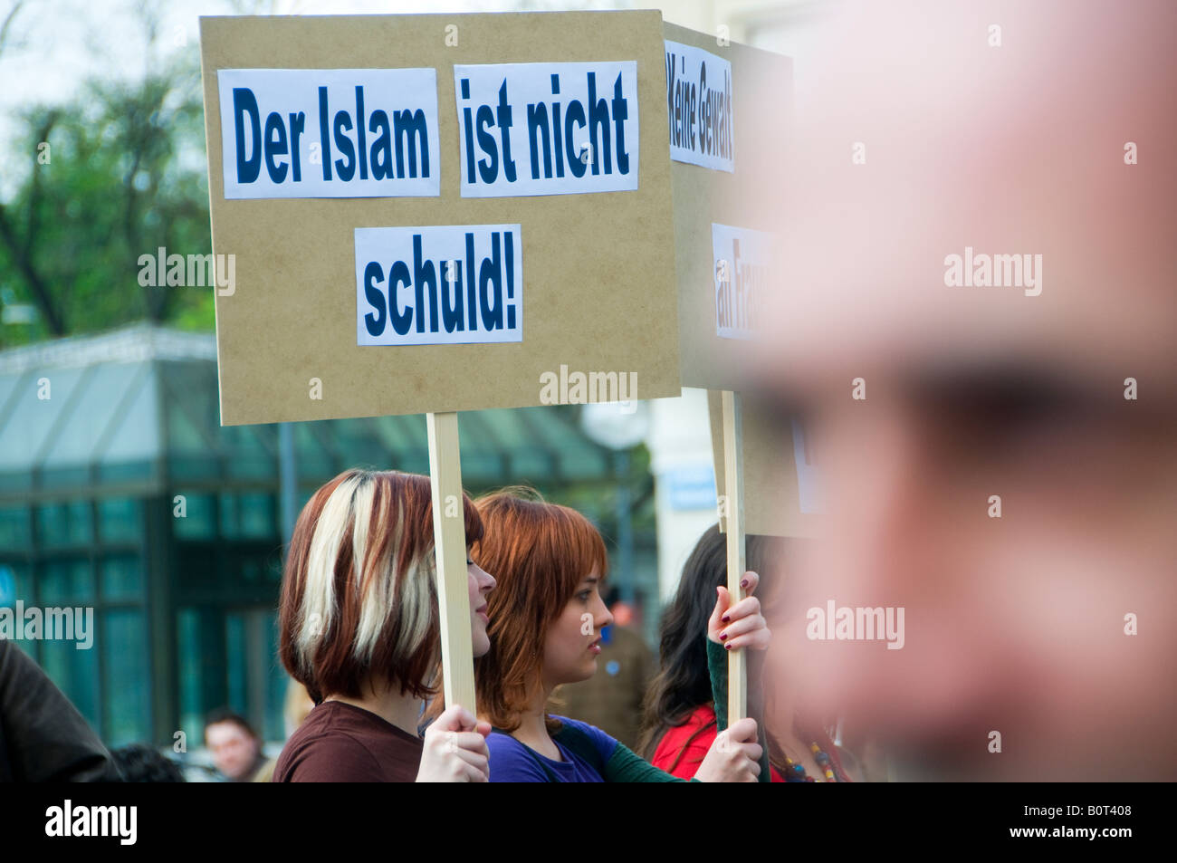 German woman holding a cardboard sign which reads "Islam is not bad ...