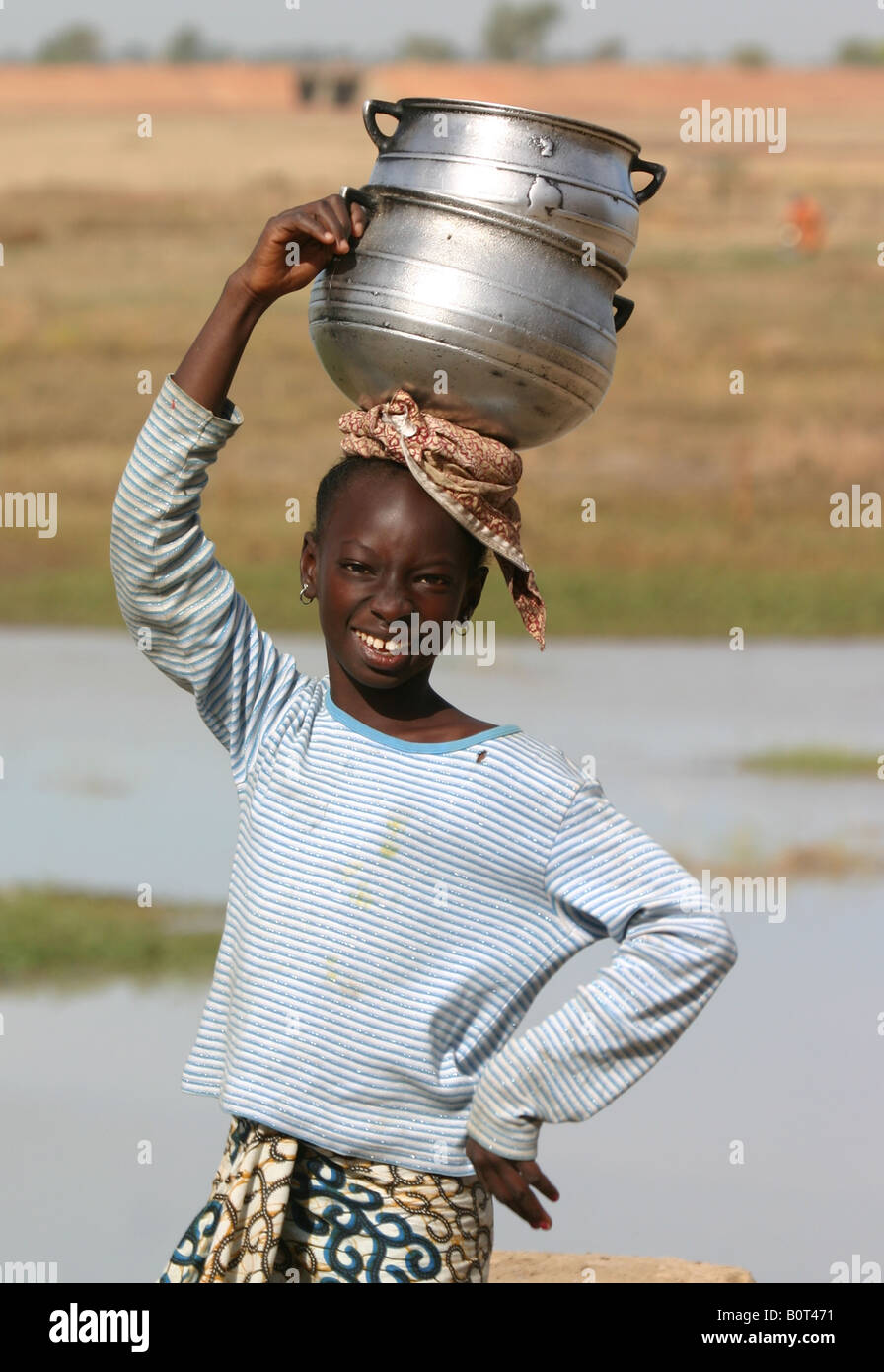Peul girl carrying milk Stock Photo - Alamy