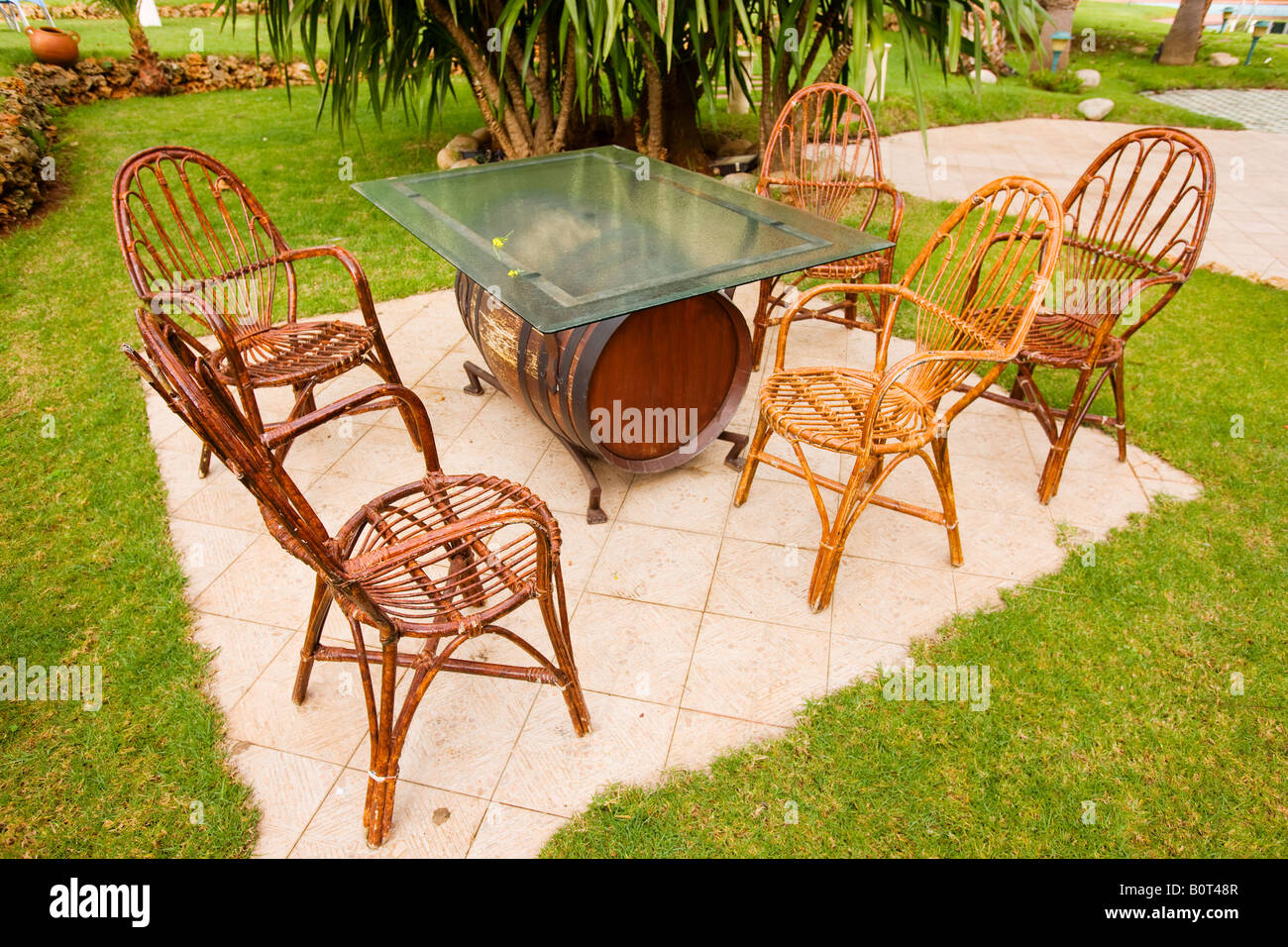 Backyard patio in the rainy morning Outdoors table and 5 chairs close ...