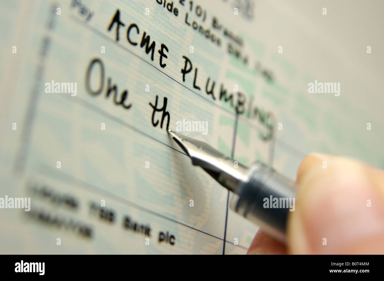 Writing a cheque Stock Photo - Alamy