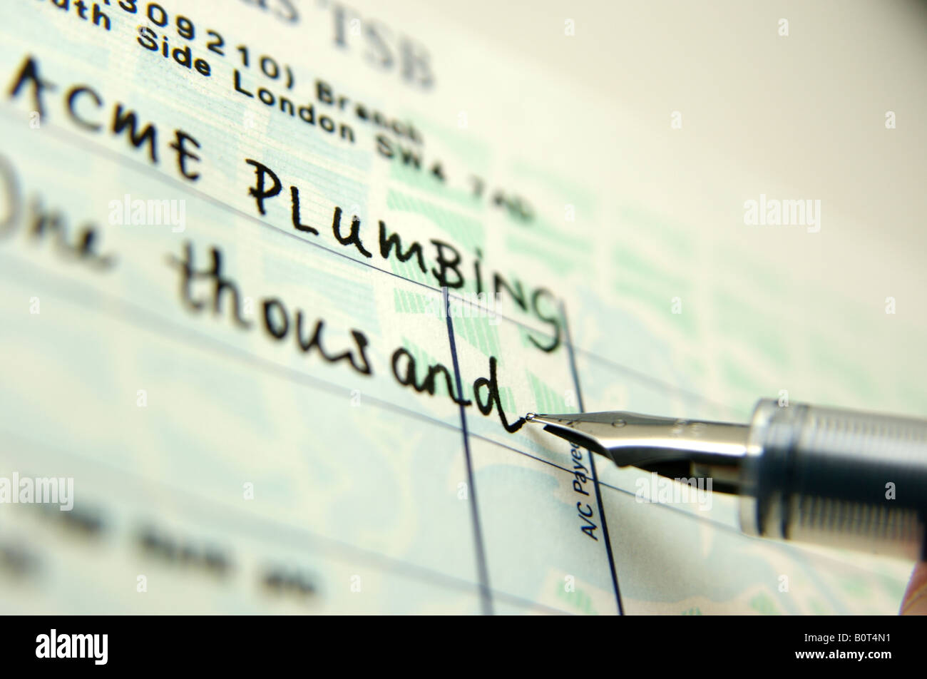 Writing a cheque Stock Photo - Alamy