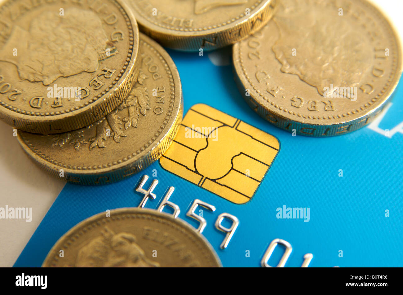 Credit card sim with coin Stock Photo - Alamy