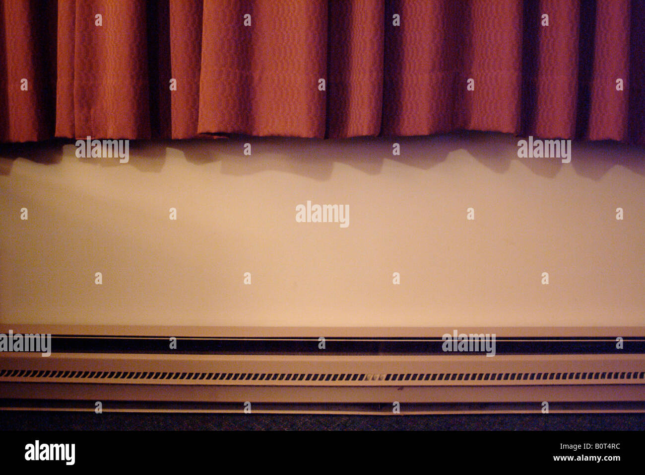 Motel room wall, red curtain, baseboard heater Stock Photo - Alamy