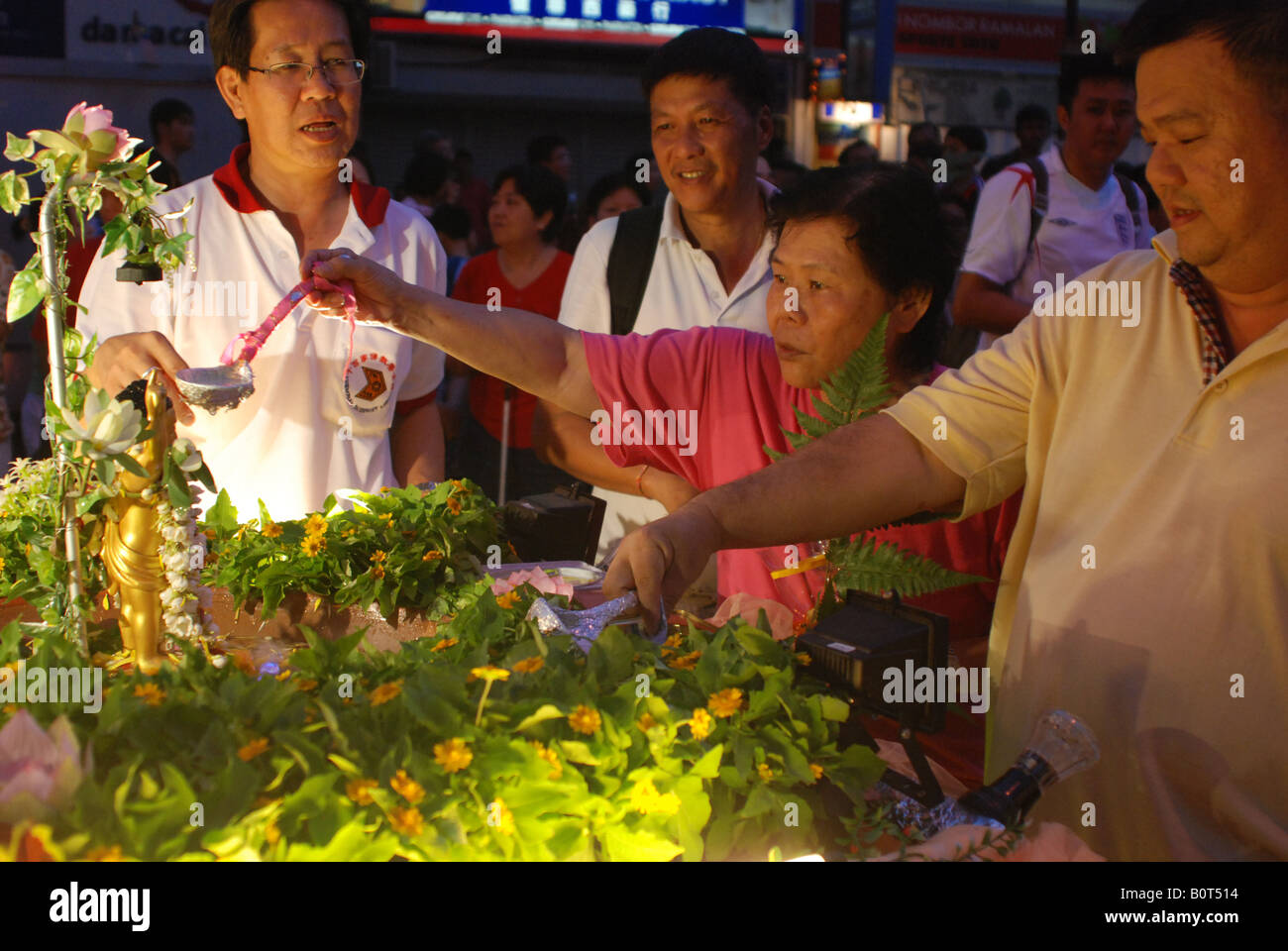 Buddhist devotees bathing buddha statue hi-res stock photography and ...