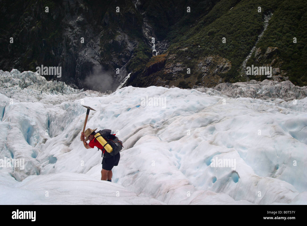 Guide cutting steps on Fox Glacier, New Zealand Stock Photo - Alamy