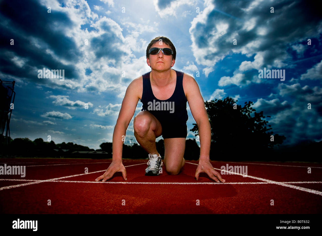 Dramatic image of Runner on starting blocks Stock Photo - Alamy