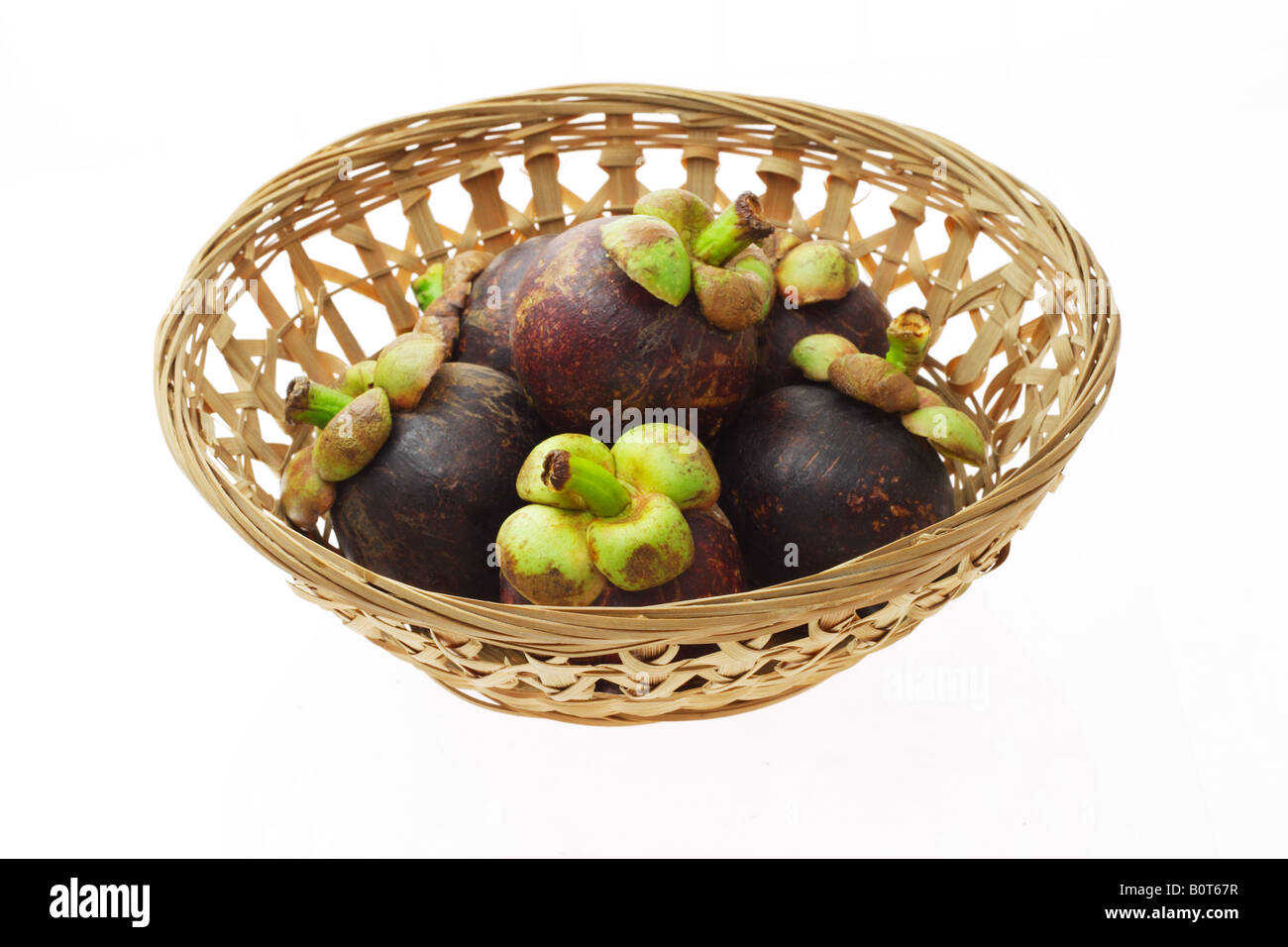 Mangosteens in basket isolated on white background Stock Photo - Alamy