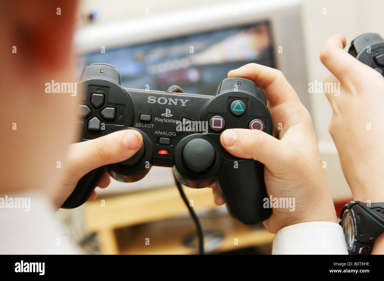 Boy holding a Playstation controller Stock Photo - Alamy