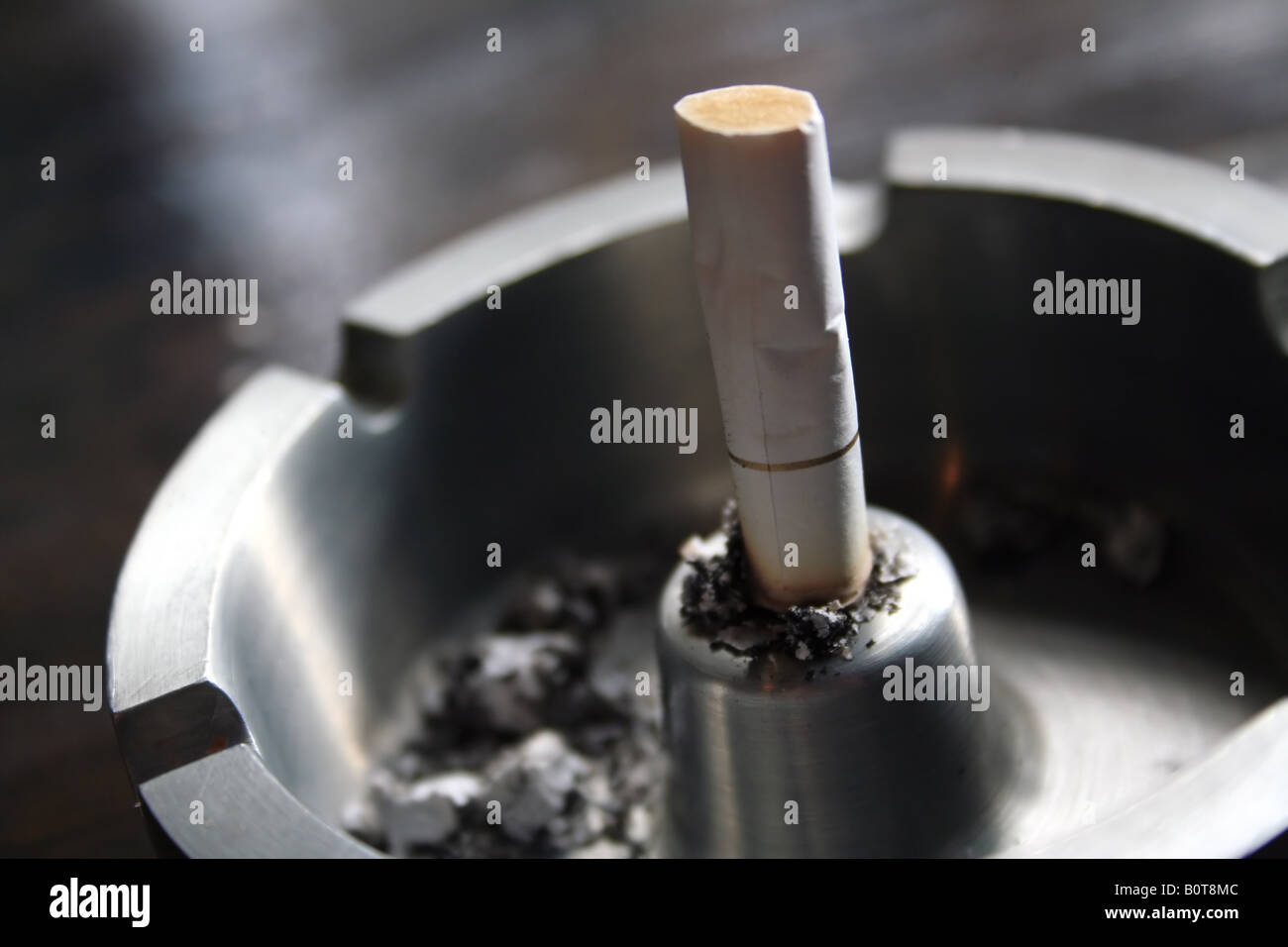 Extinguished cigarette and metallic ashtray detail and close up Stock ...