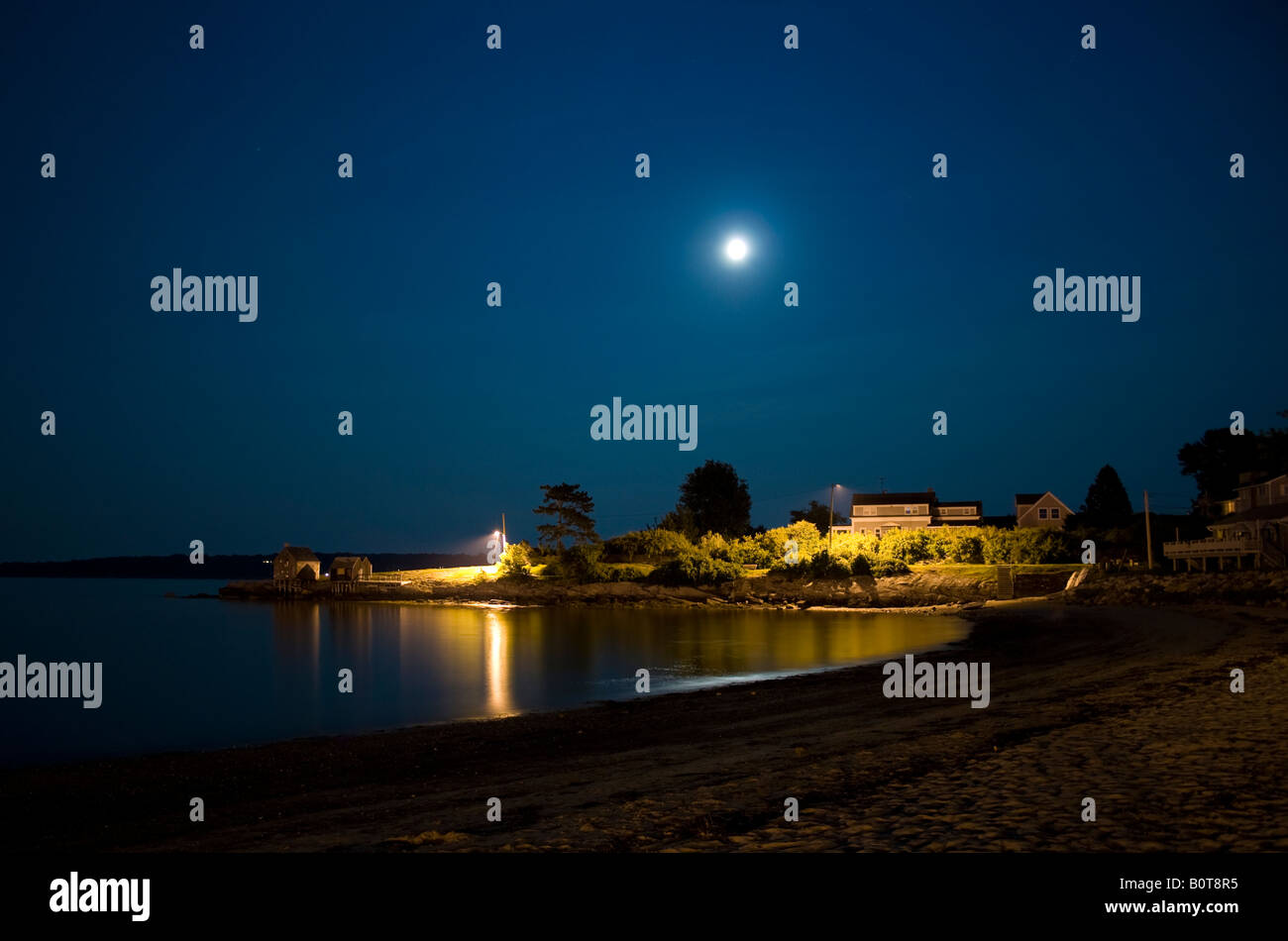 The moon rises over the extremity of Willard Beach in Maine Stock Photo ...