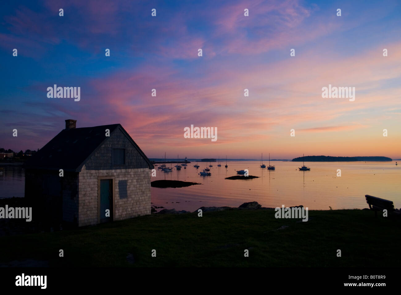 An abandoned lobster shack on the extremity of a rocky outcrop in Maine ...