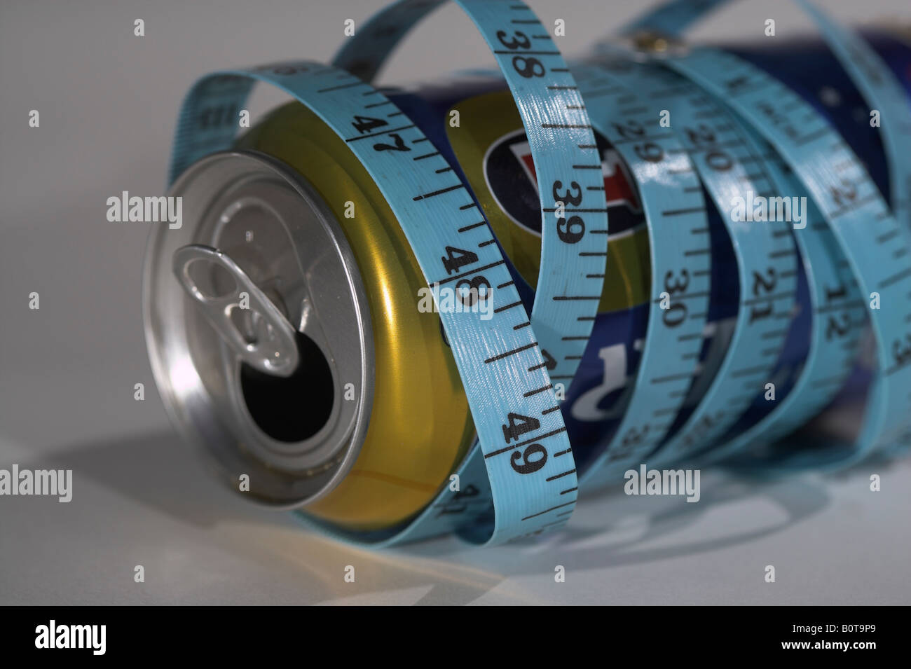 Empty can of beer with tape measure wrapped round it Health and diet ...