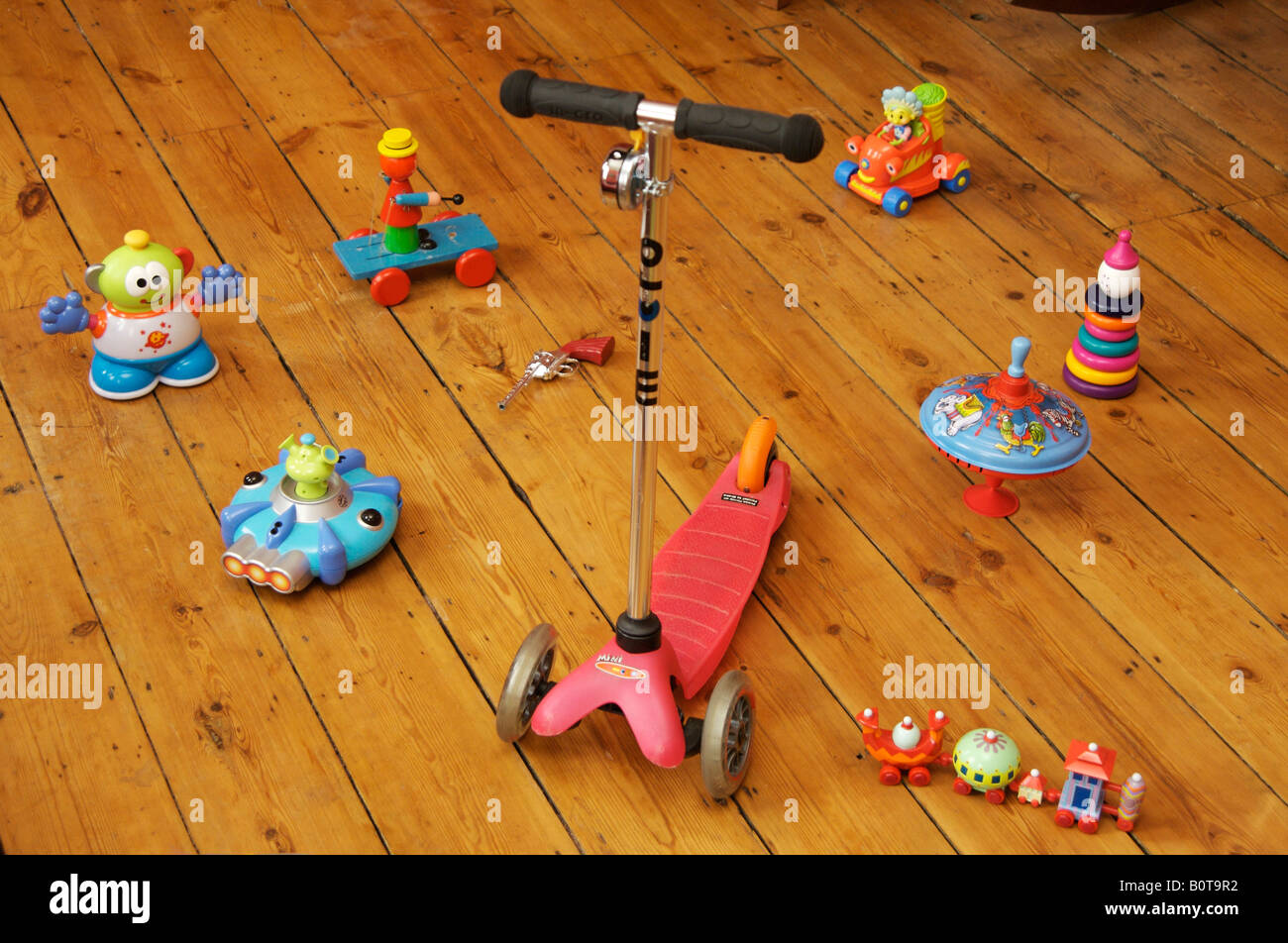 Children's toys spread out over wooden floor Stock Photo - Alamy