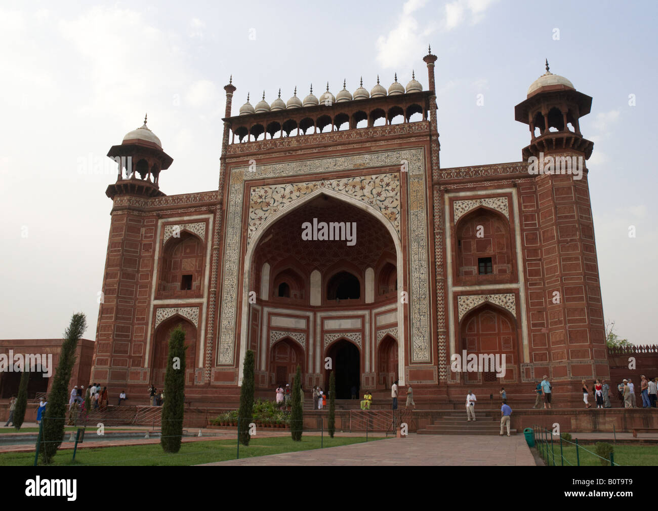 A vast red sandstone gateway leads to the inner compound of the Taj ...