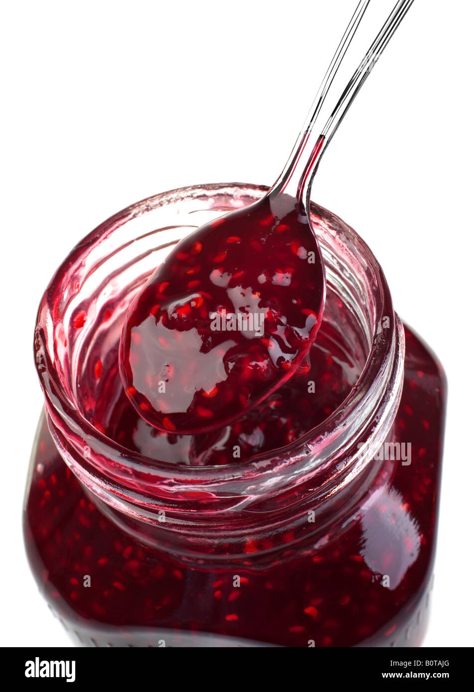 Raspberry confiture in glass with metal spoon isolated on white Stock ...