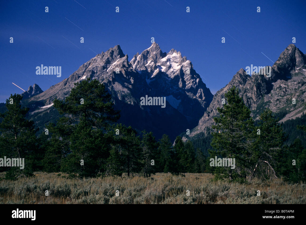 Star streaks at night over the Grand Tetons by light of full moon Grand ...