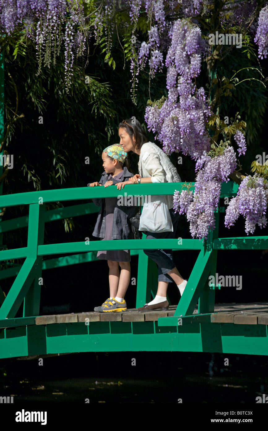 Oriental mother and daughter on a bridge in Monet's Garden, Giverny ...