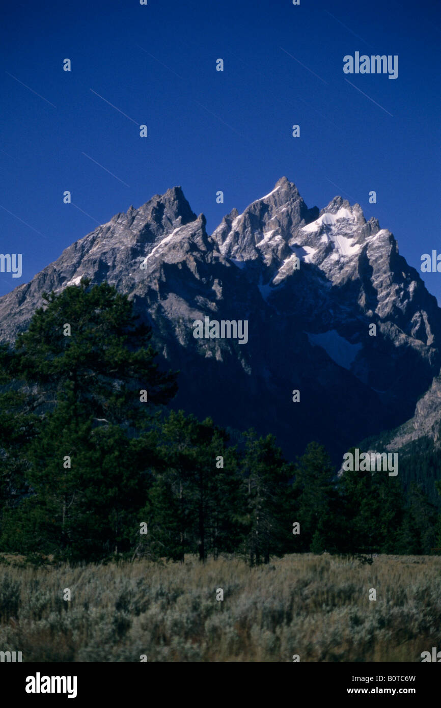 Star streaks at night over the Grand Tetons by light of full moon Grand ...