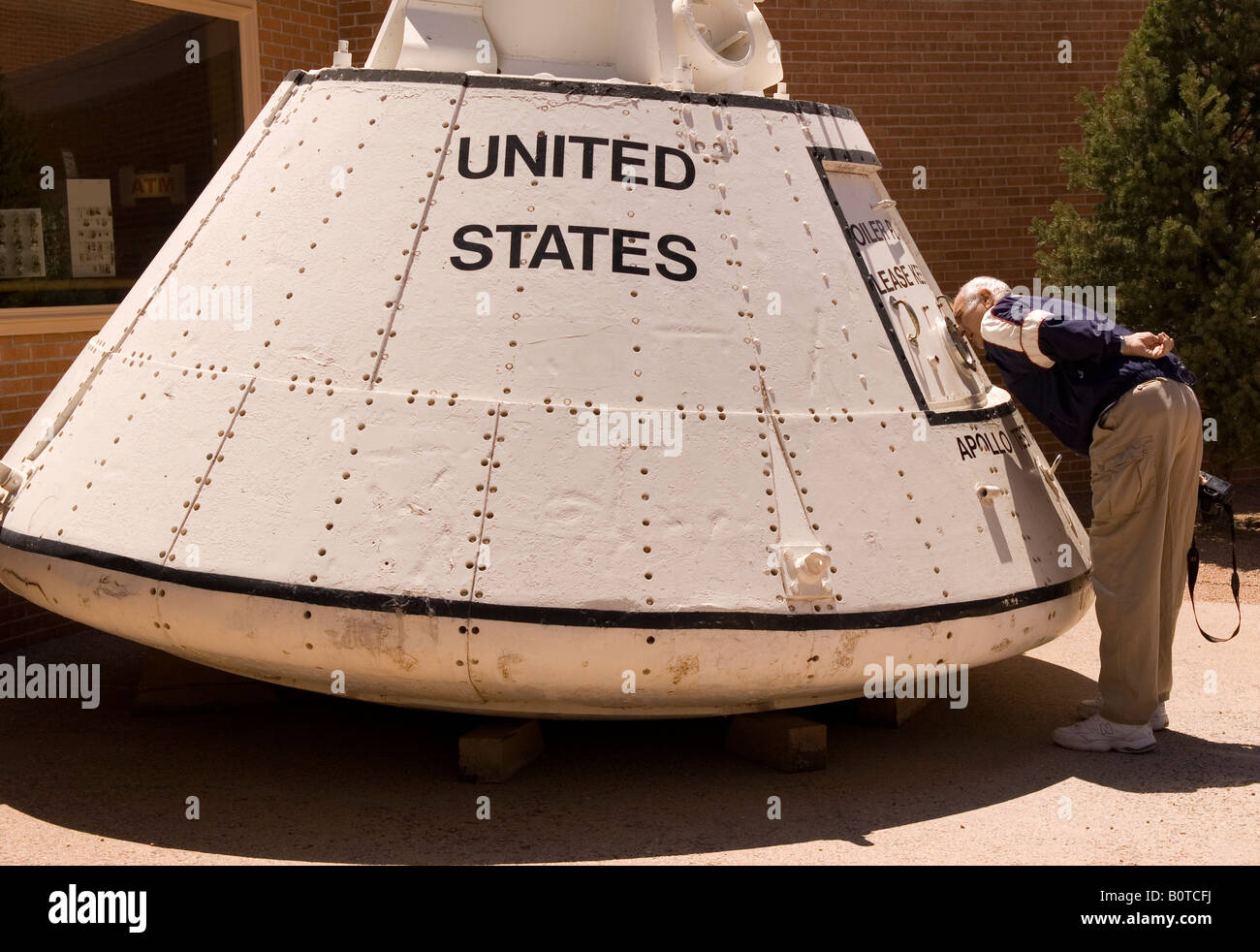 Caucasian Man (60-65) Looks at Apollo Test Capsule at Meteor Crater in ...