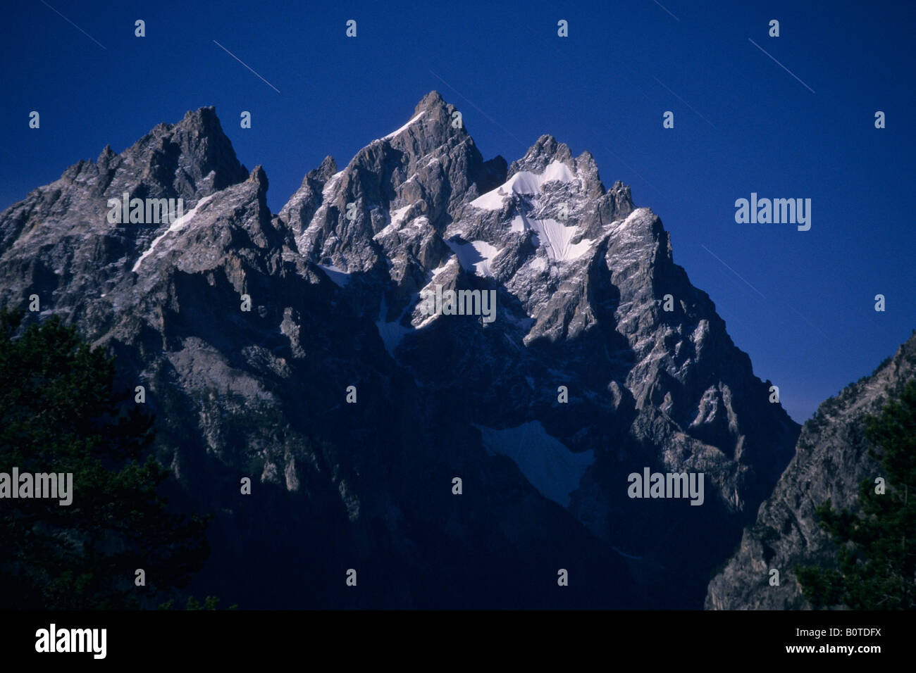 Star streaks at night over the Grand Tetons by light of full moon Grand ...