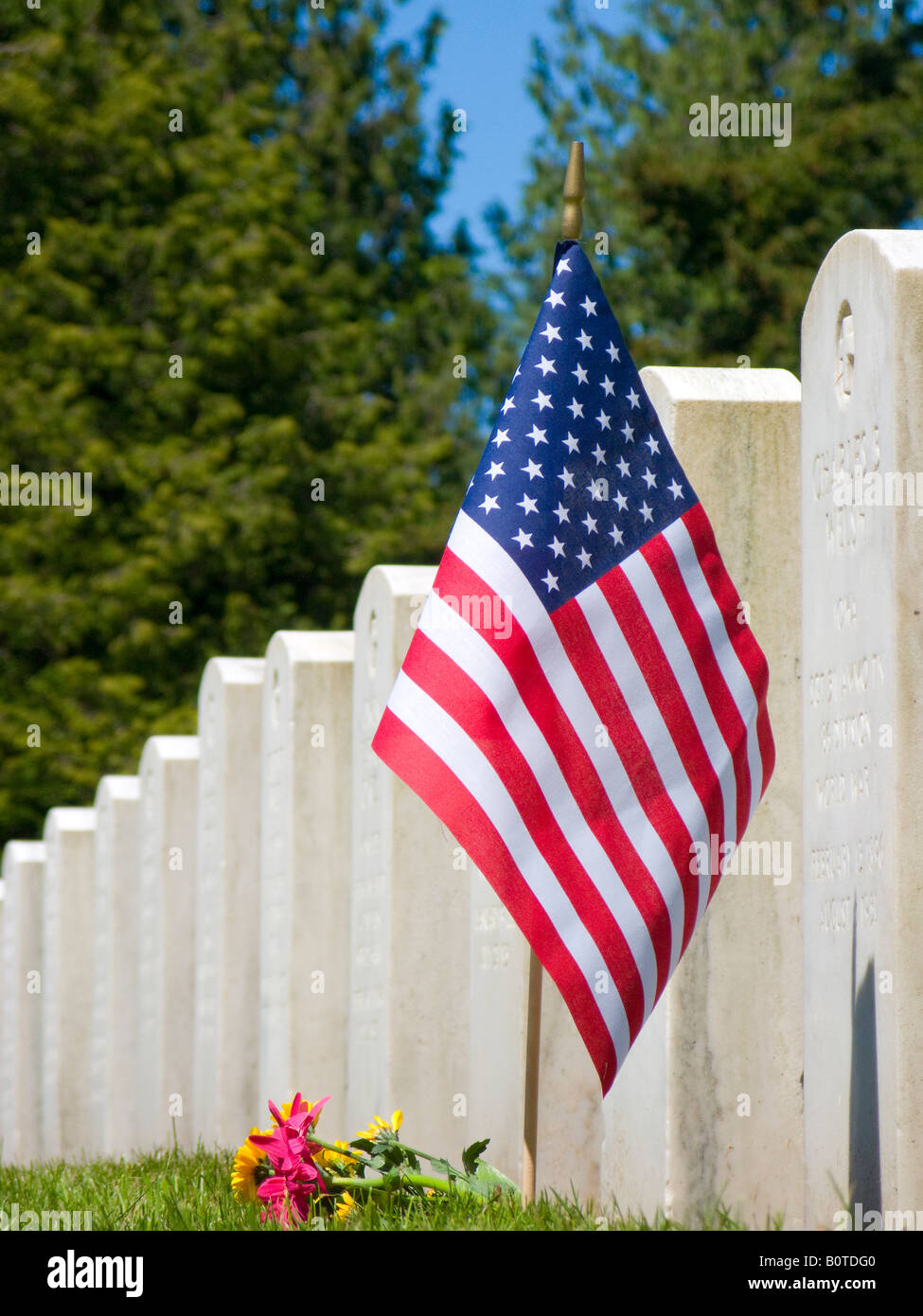 A single US Flag stands by a headstone at the Veterans Memorial ...