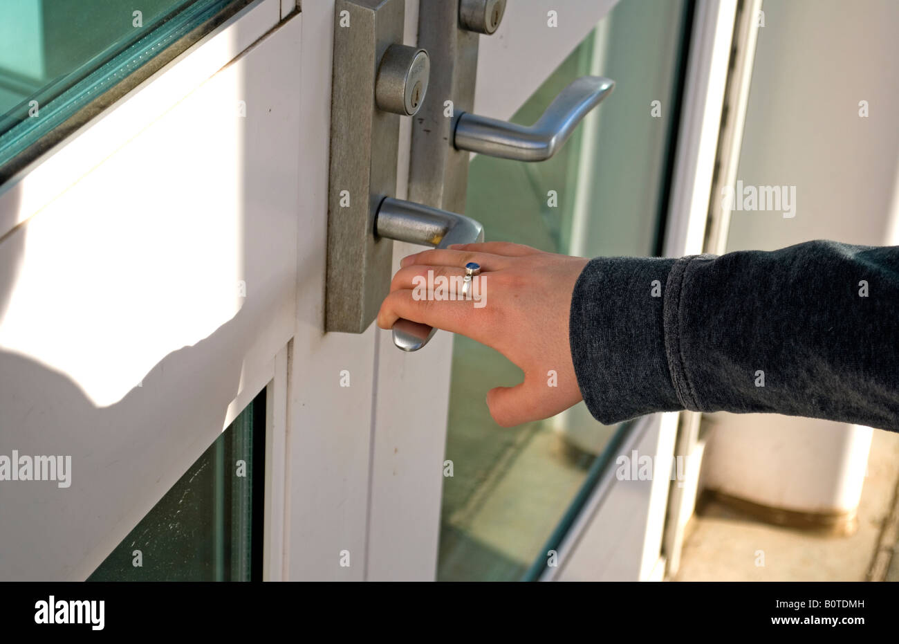girl opening a door, trying to get inside Stock Photo - Alamy