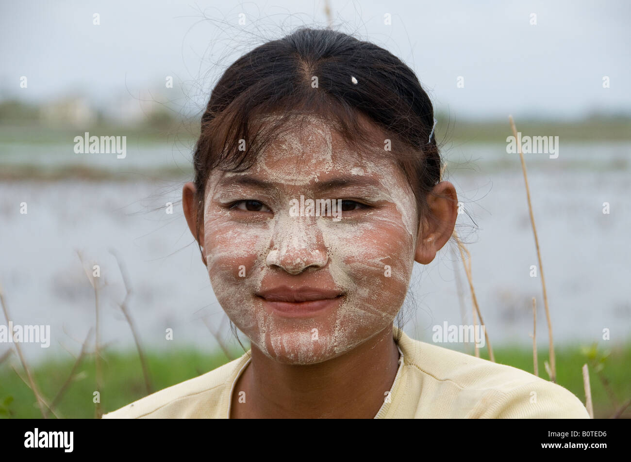 Young Burmese woman wearing typical Thanaka cosmetic mask in a rural ...