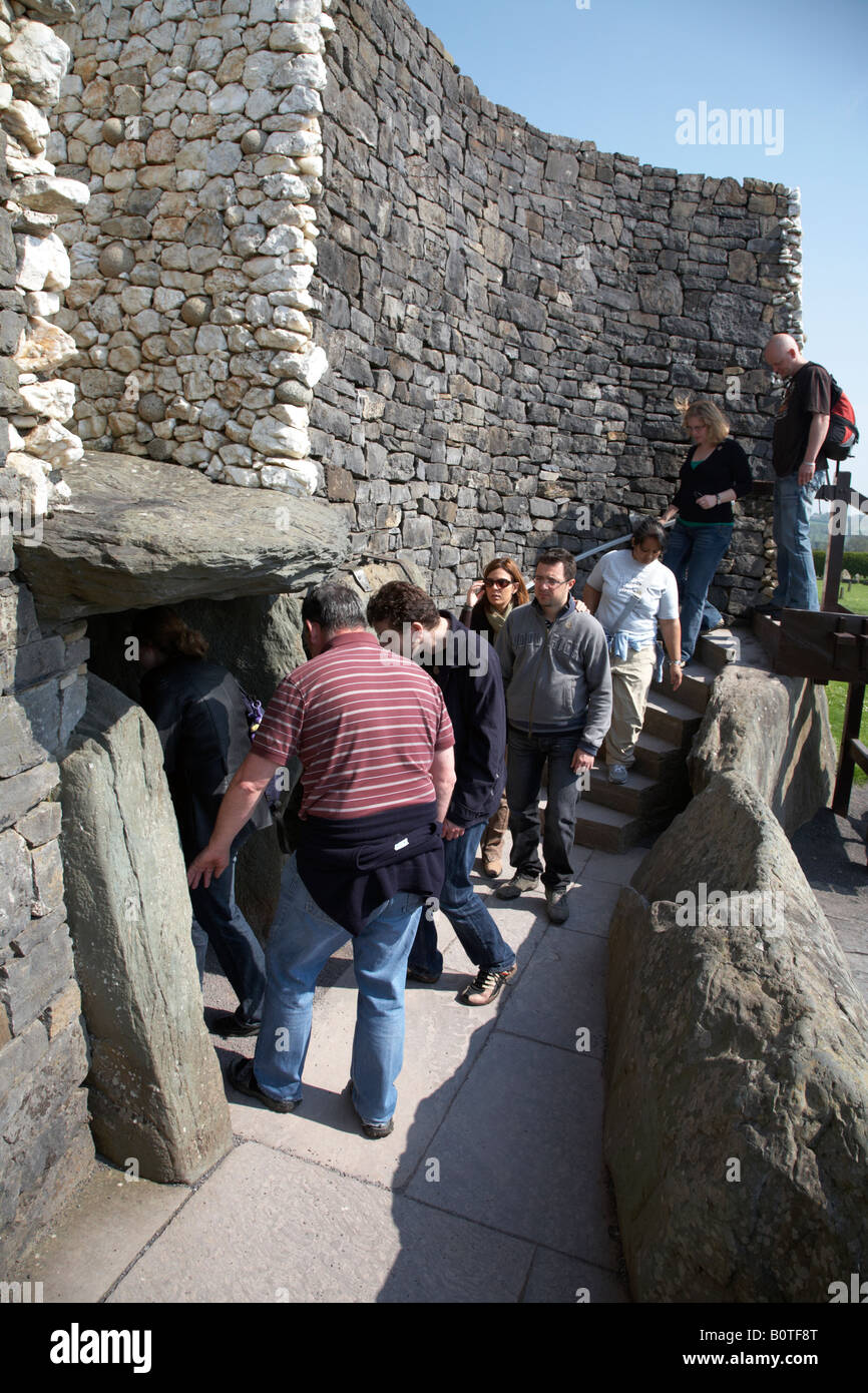 tour group entering the passage tomb at newgrange over walkway on ...