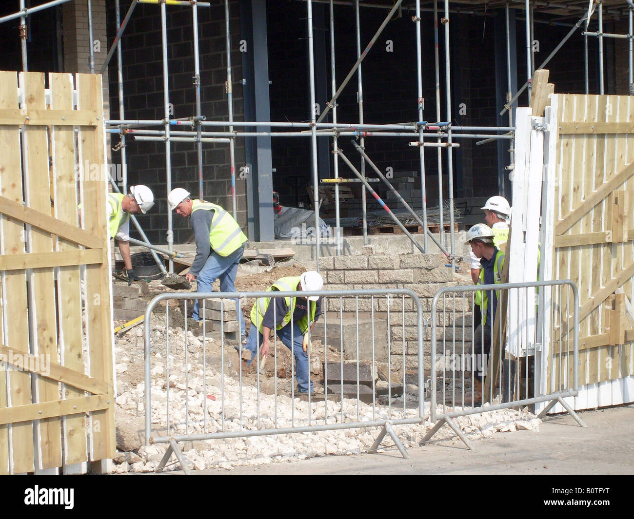 Bricklayers on building site, in North Bay development, Scarborough ...