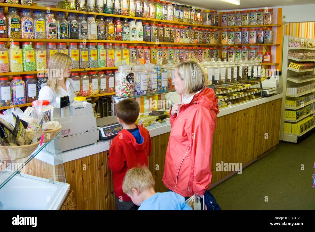 Mother And Children Buying Sweets At Traditional English Sweet Shop in ...