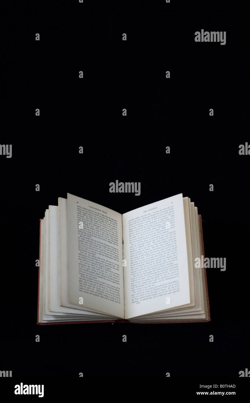 Open book on a black background Stock Photo - Alamy