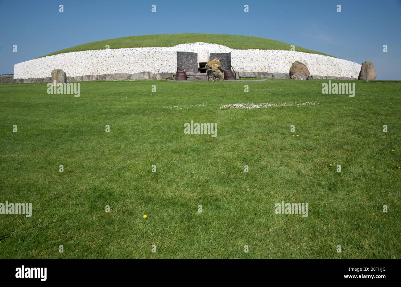 front of newgrange megalithic burial mound and standing stones under a ...