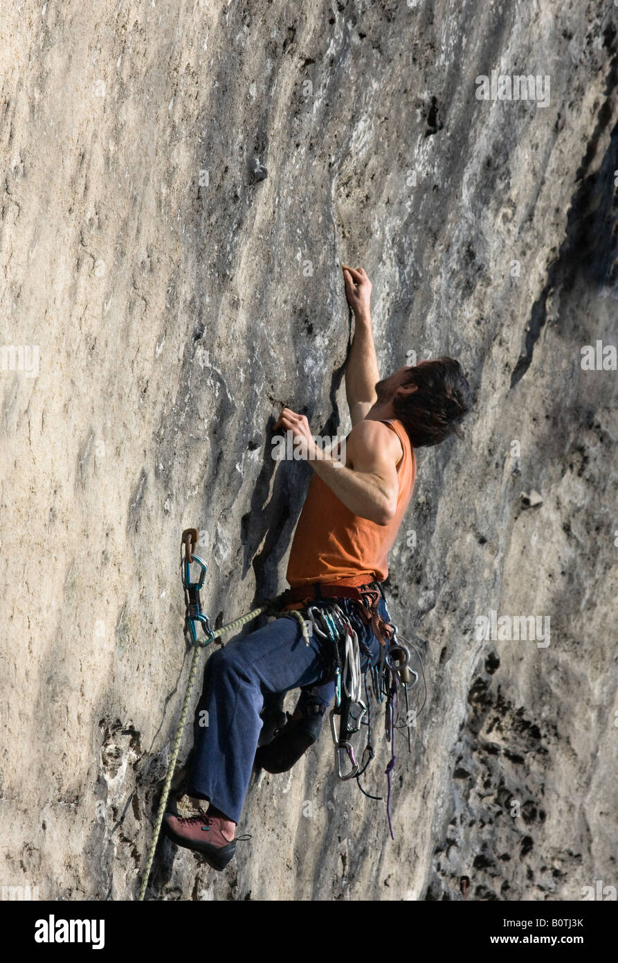 Rock climber climbing a route on Goldstein in the Elbsandsteingebirge ...