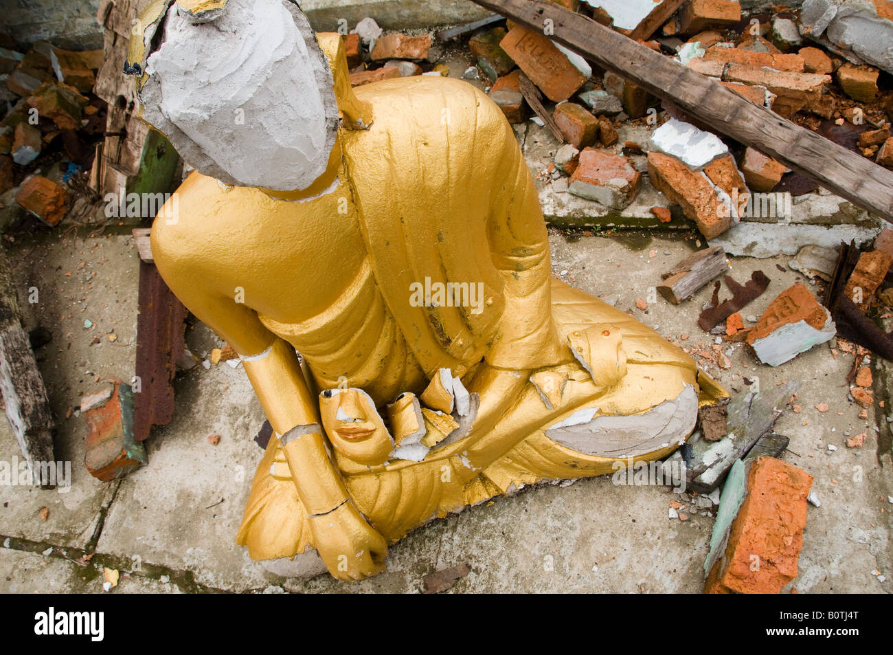 A large Buddha statue stands in a ruined temple caused by Cyclone ...