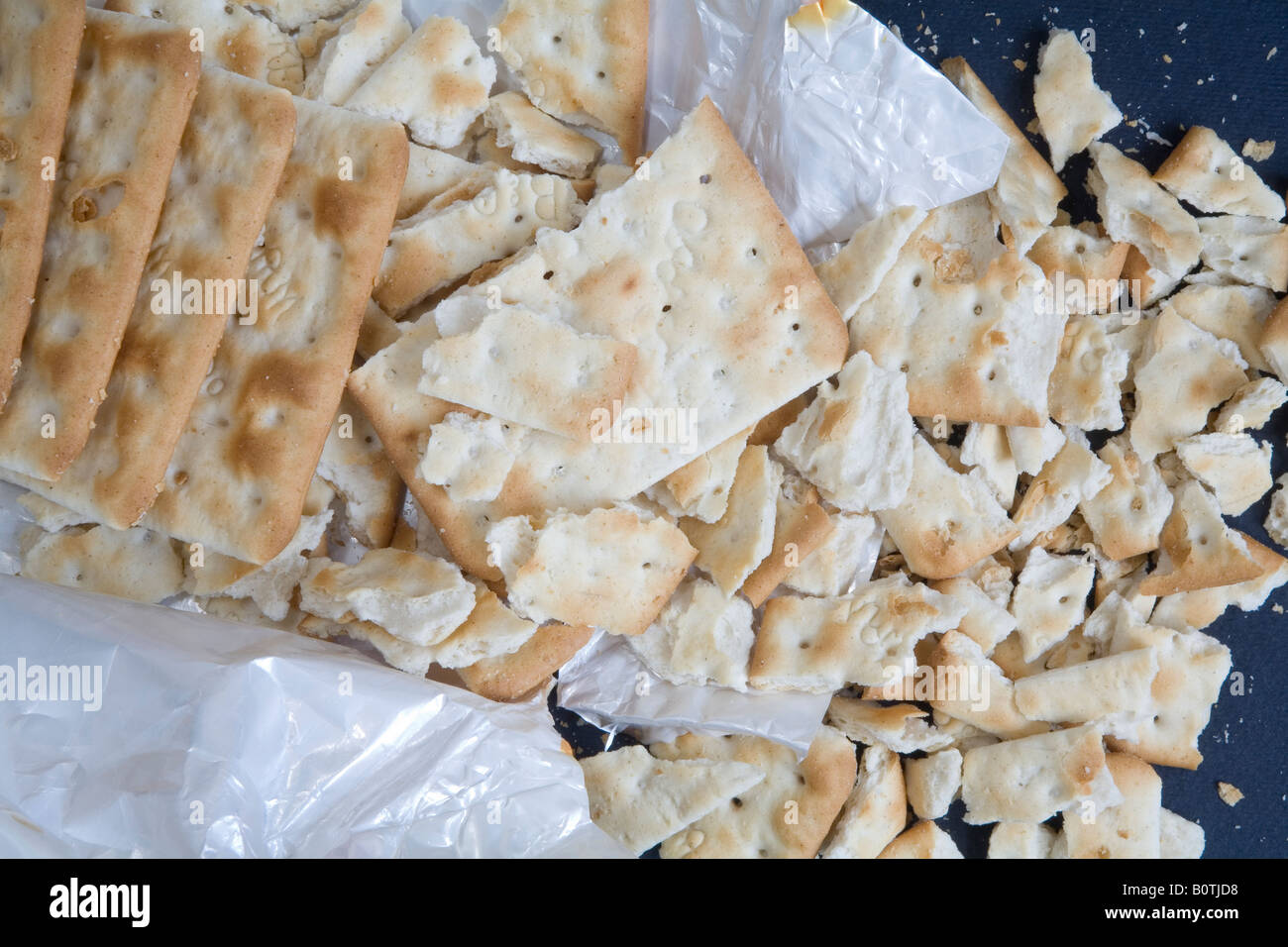 A packet of smashed cream cracker biscuits burst open Stock Photo - Alamy