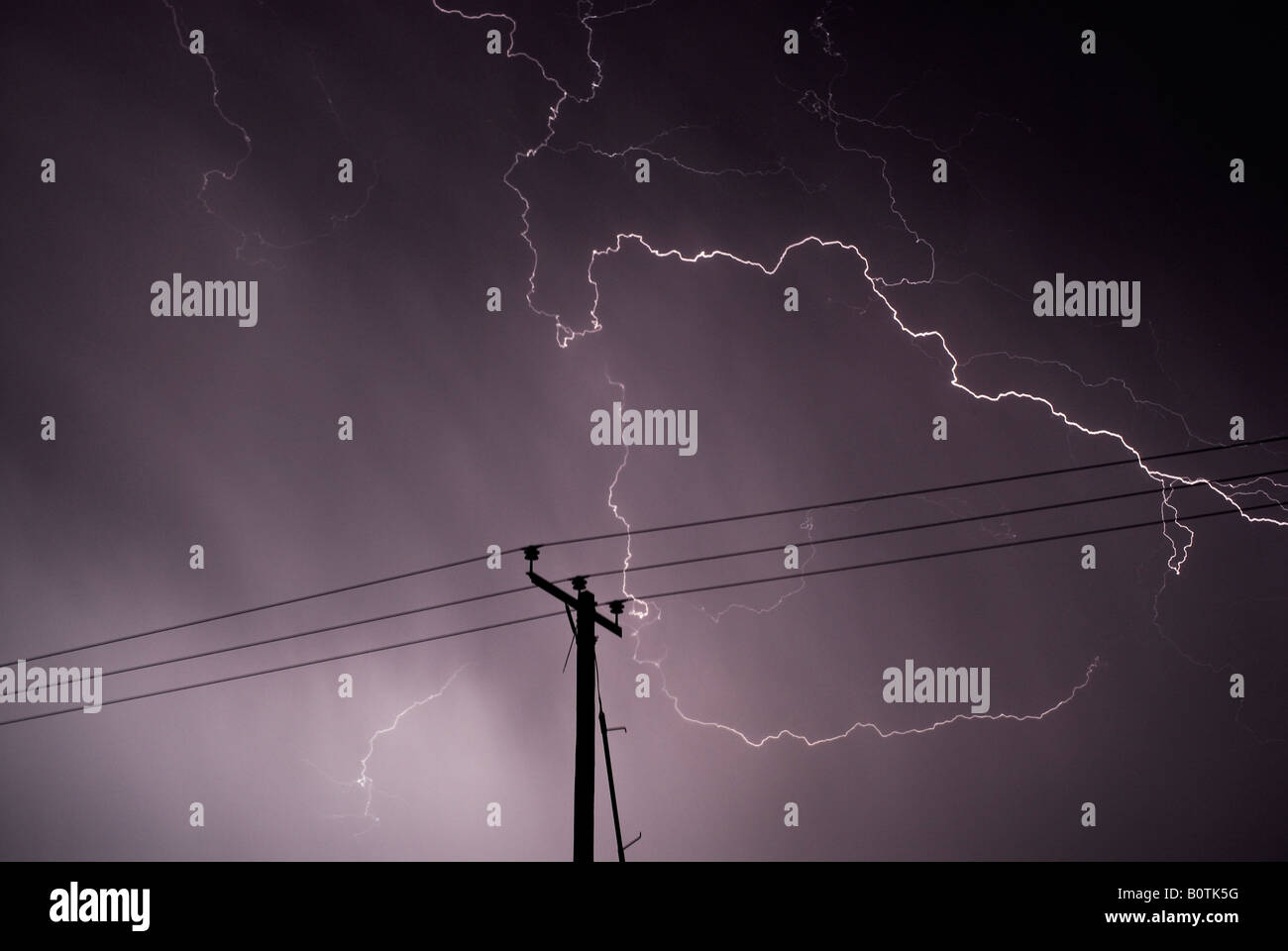 Bolt of lightning and electricity pylon at night Stock Photo - Alamy