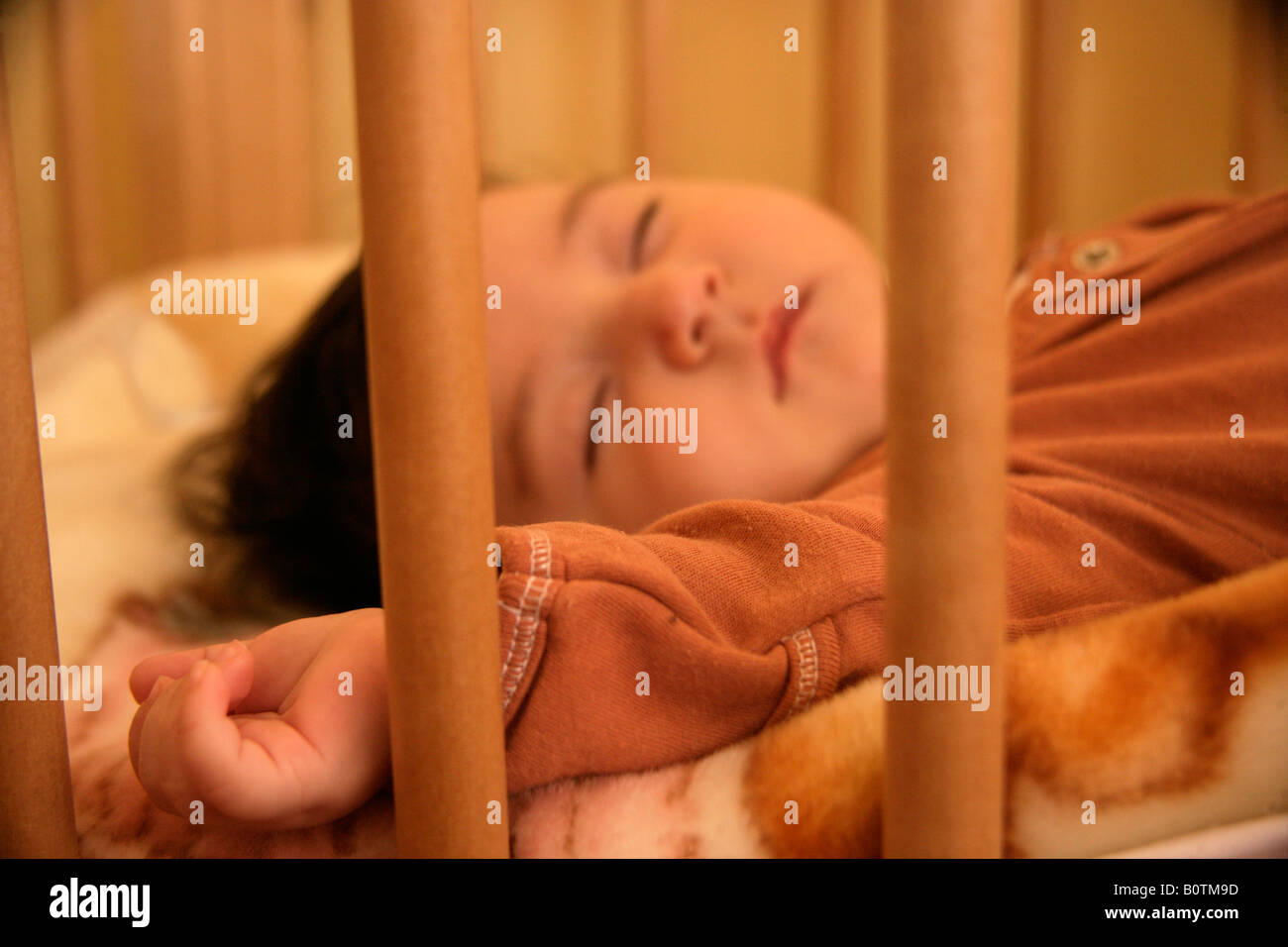 Baby asleep in cot Stock Photo - Alamy